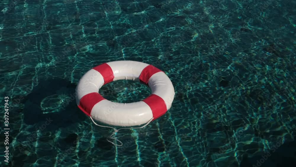 Lifebuoy Floating. Red life buoy over clear blue sea or ocean water ...