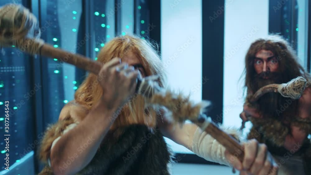 Prehistoric cavemen in animal fur growling fiercely at camera, hunting ...