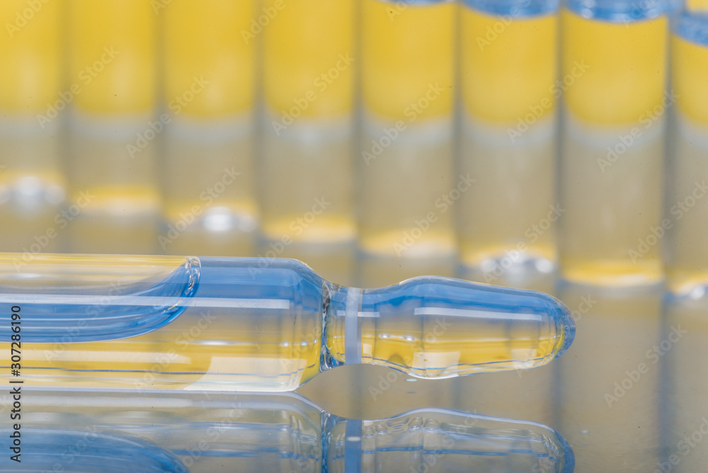 Glass medical ampoule vial for injection. Medicine is liquid sodium ...