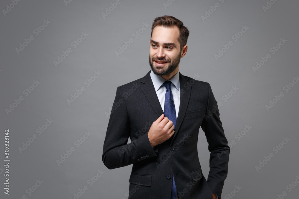 Smiling young bearded business man in classic black suit shirt tie ...