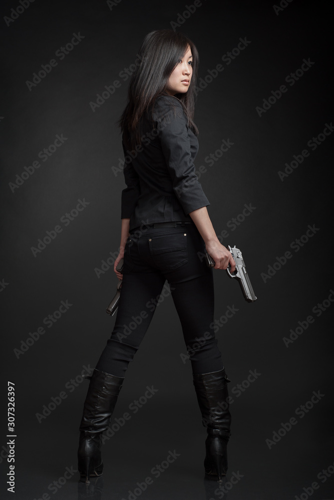 Young woman with pistols Stock Photo | Adobe Stock
