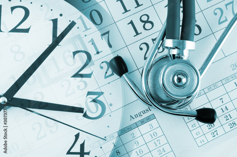 Regular medical examination concept, stethoscope on calendar and clock ...