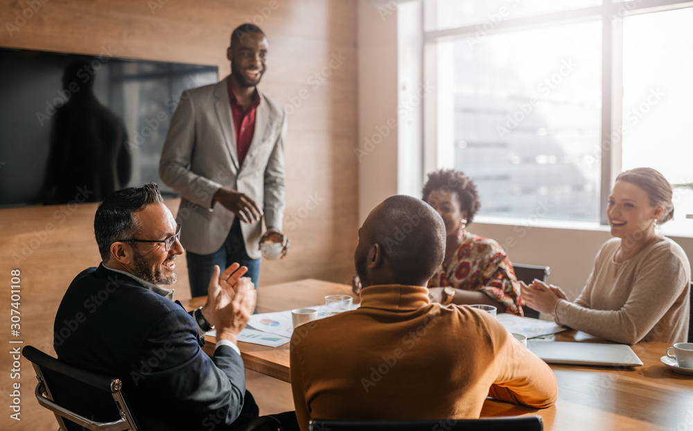 Candid and real boardroom meeting with diverse South African business ...