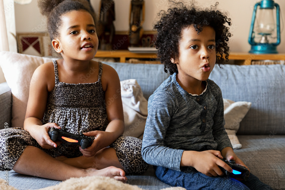 Kids playing video game Stock Photo | Adobe Stock