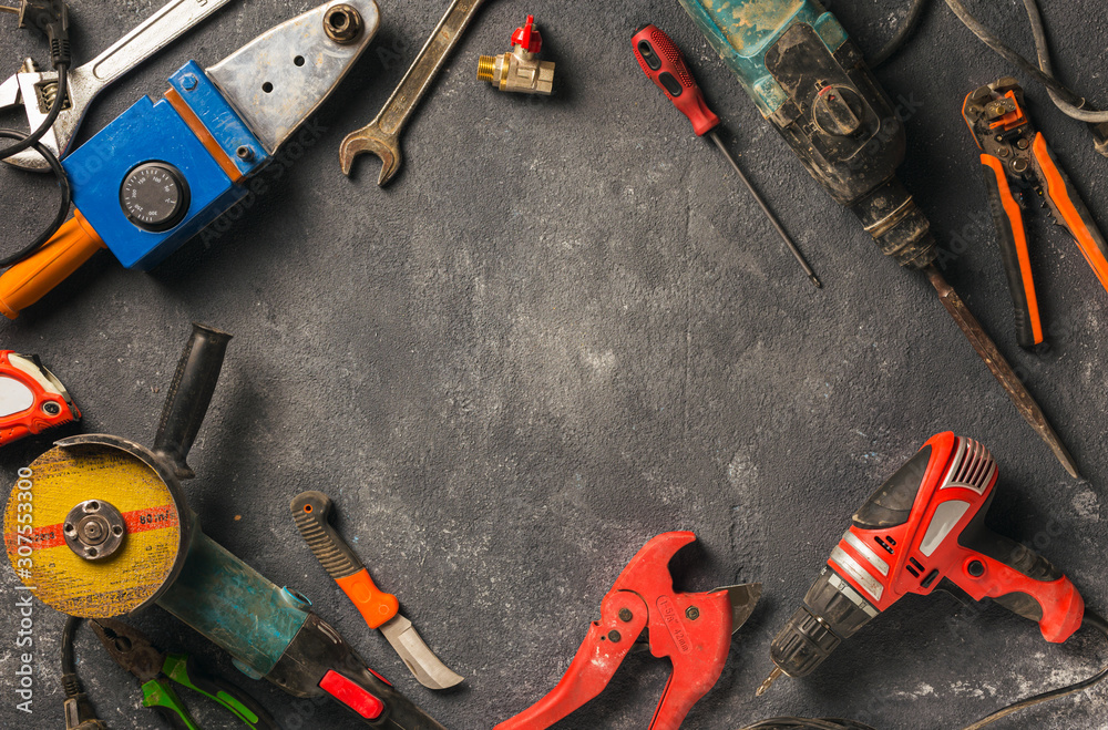 Frame of construction worker tools on a dark background top view ...