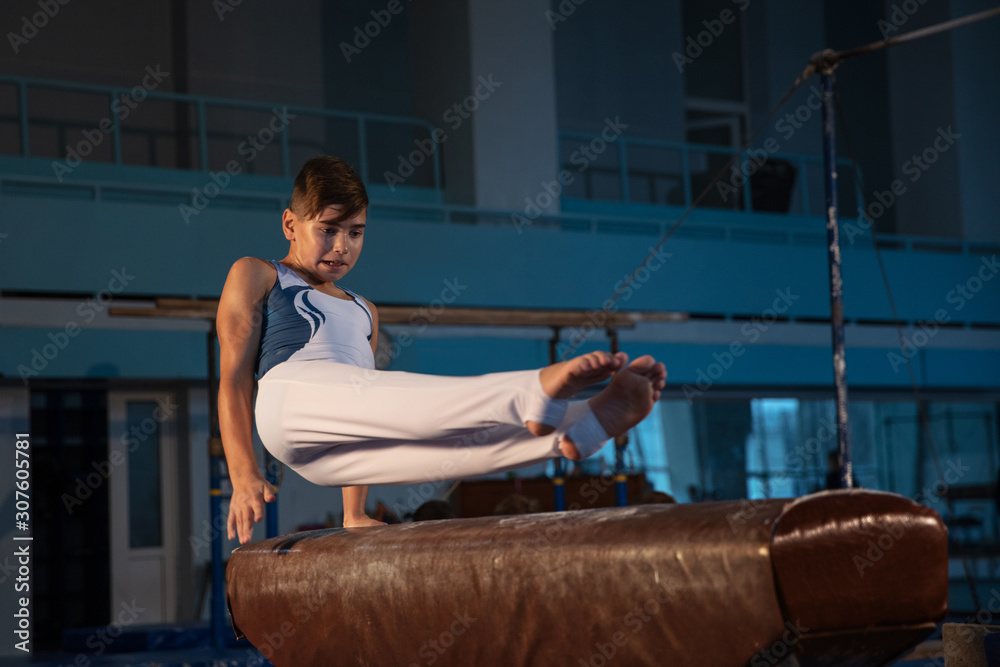Little male gymnast training in gym, flexible and active. Caucasian fit ...