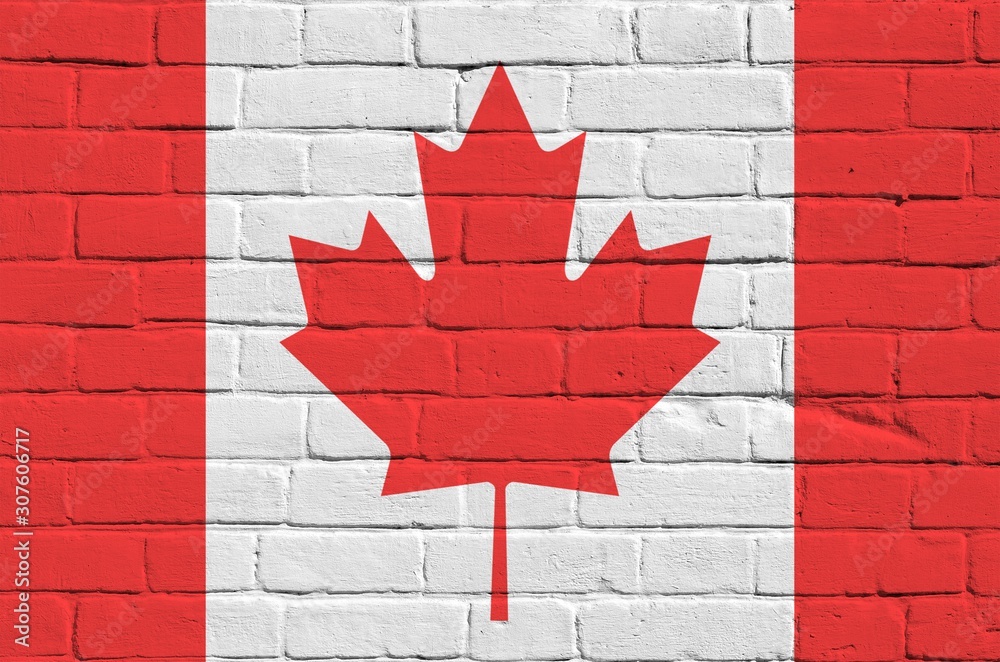 Canada flag depicted in paint colors on old brick wall. Textured banner ...