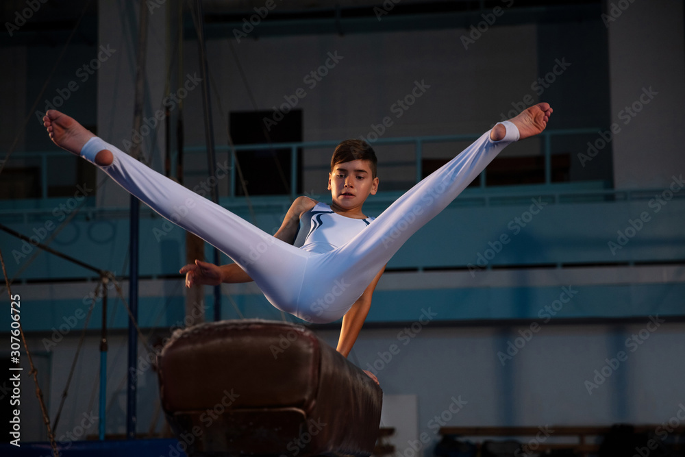 Little male gymnast training in gym, flexible and active. Caucasian fit ...