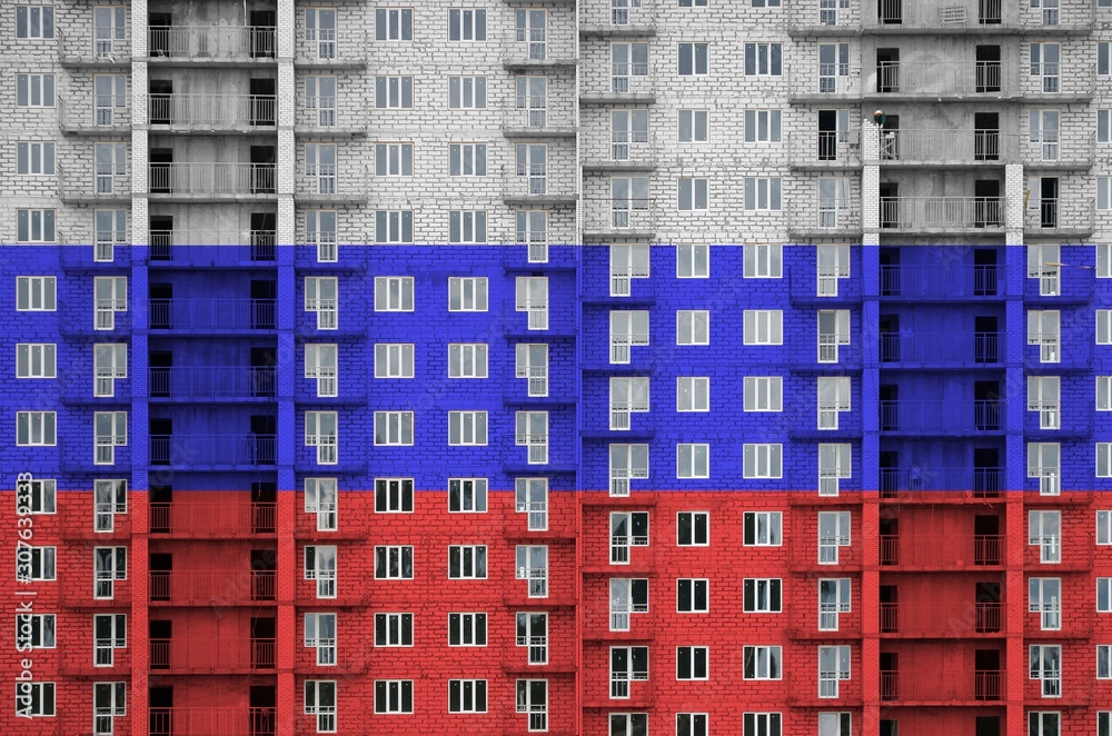 Russia flag depicted in paint colors on multi-storey residental ...