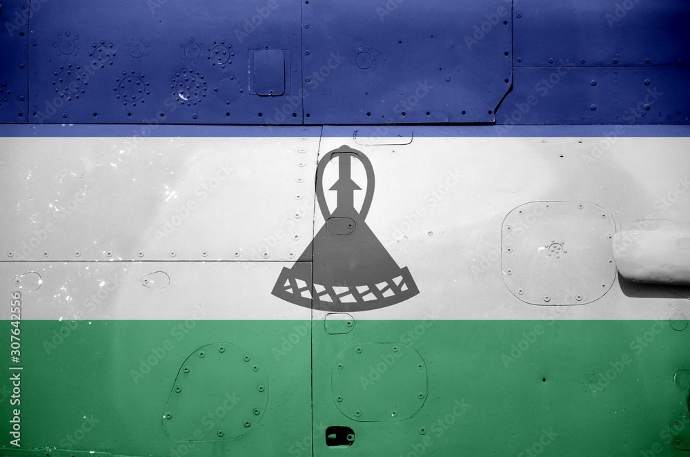 Lesotho flag depicted on side part of military armored helicopter ...