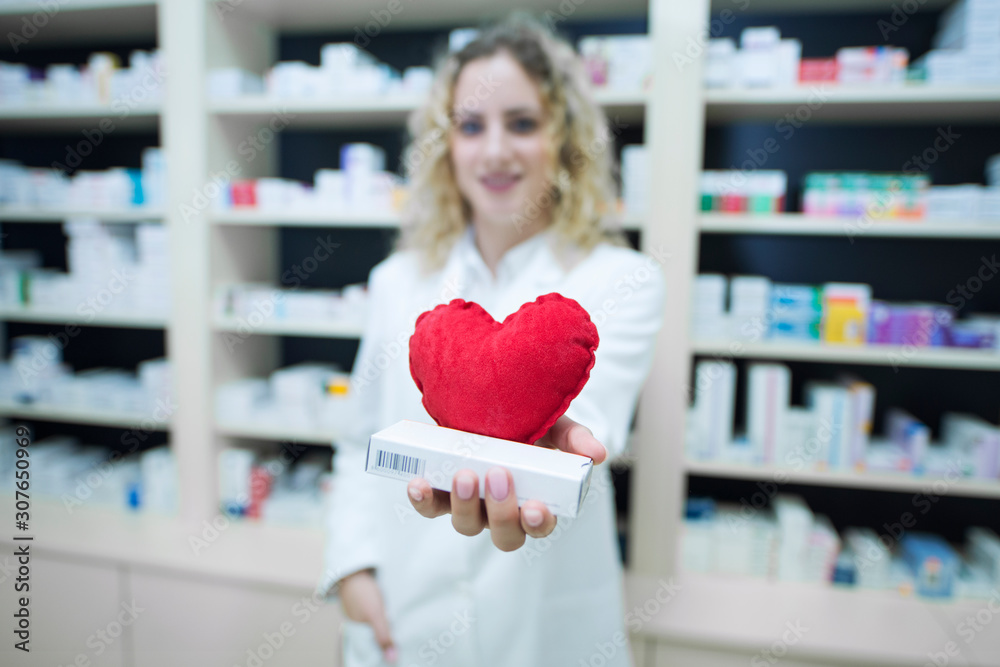 Pharmacist in white uniform holding medicines for cardiovascular ...