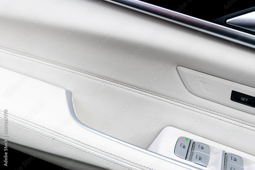 Door handle with power window control buttons of a luxury passenger car ...