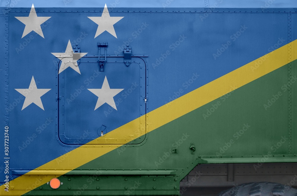 Solomon Islands flag depicted on side part of military armored truck ...