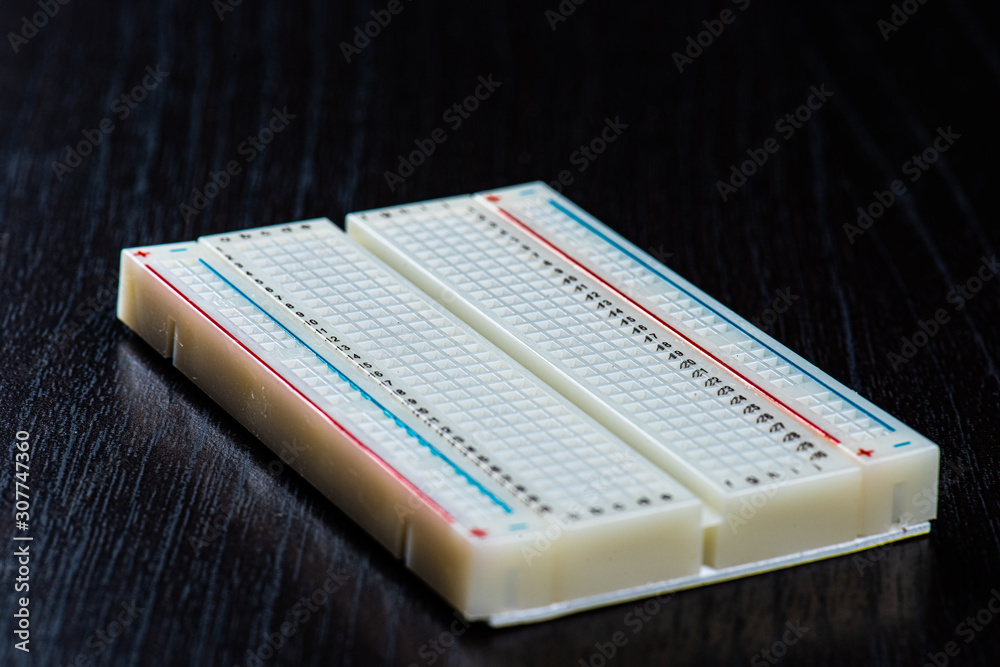 Electronics breadboard for prototyping circuits. Stock Photo | Adobe Stock