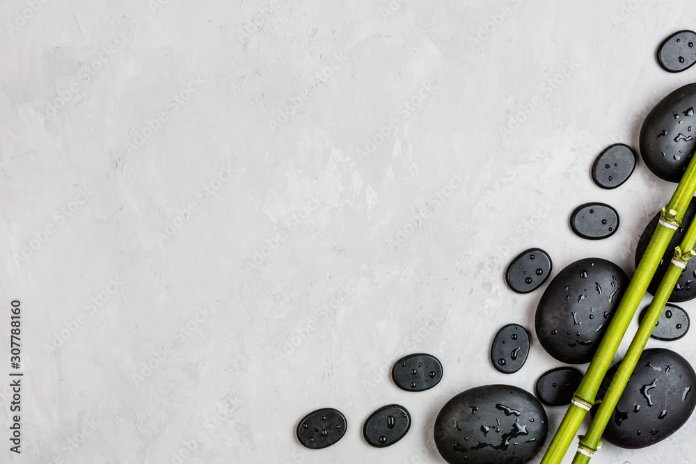 Top view of hot spa stones set for massage treatment on gray concrete ...