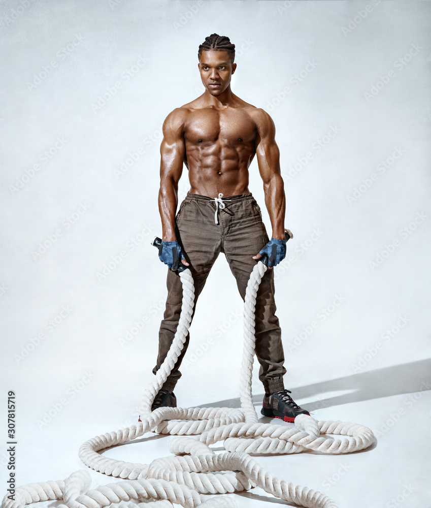 Sweaty man resting after working out with ropes. Photo of sporty man ...