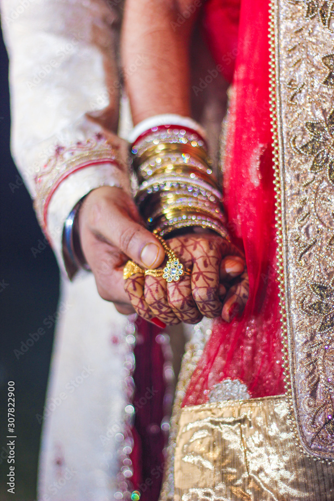 Traditional indian wedding ceremony, groom holding hand in bride hand ...