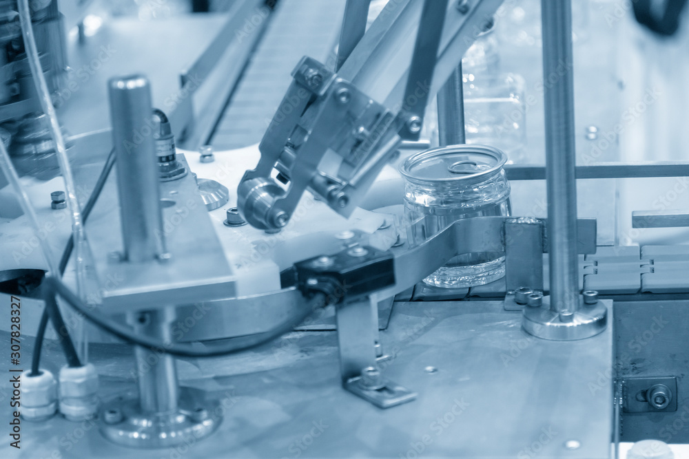 The can packaging manufacturing process in the light blue scene. The ...