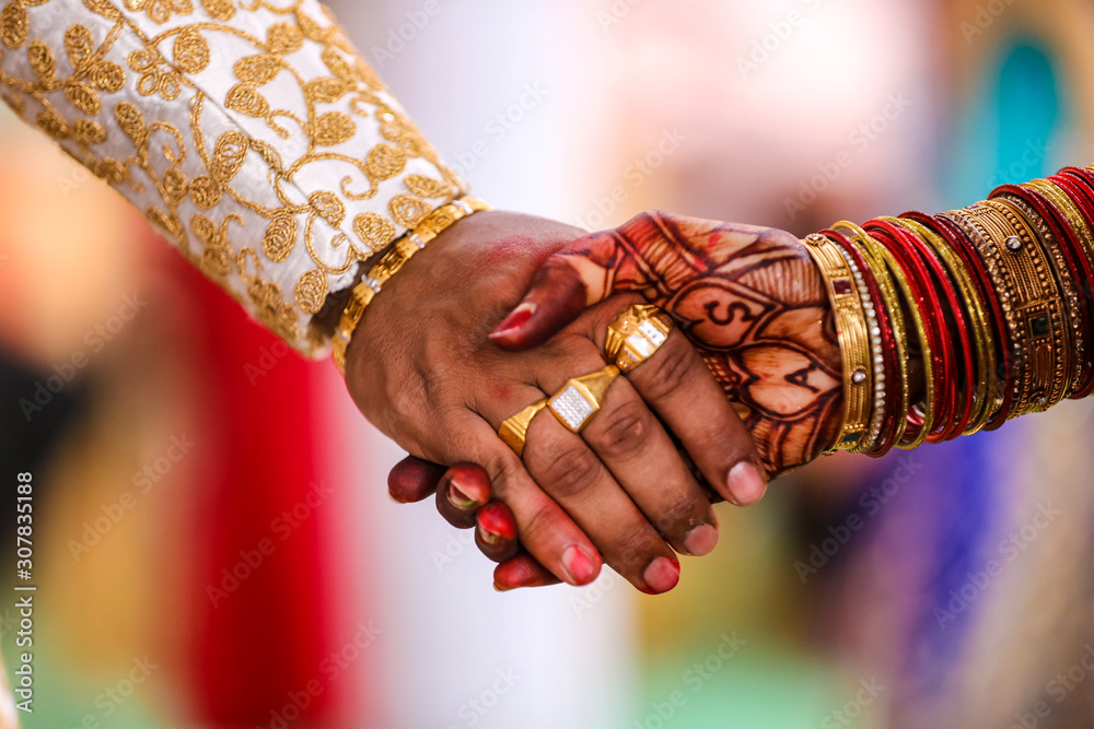 Traditional indian wedding ceremony, groom holding hand in bride hand Stock Photo | Adobe Stock