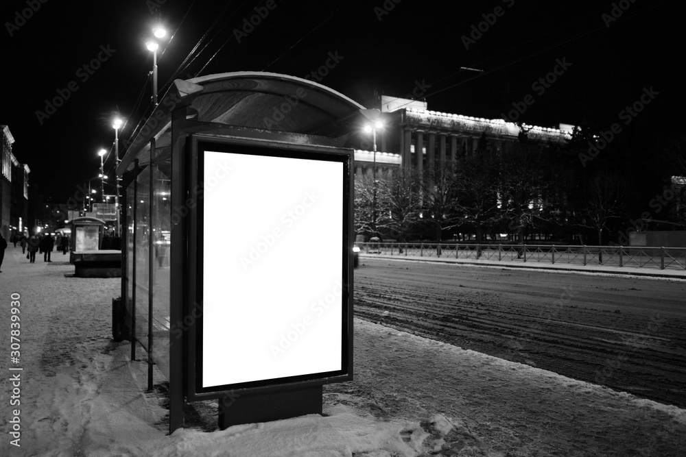 Vertical billboard in the bus stop. bus stop in the winter at night in ...