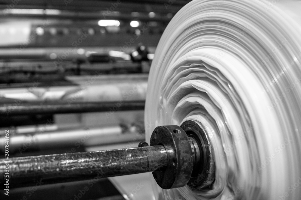 B&W imagery of spool of plastic packaging sheet heavy duty for ...