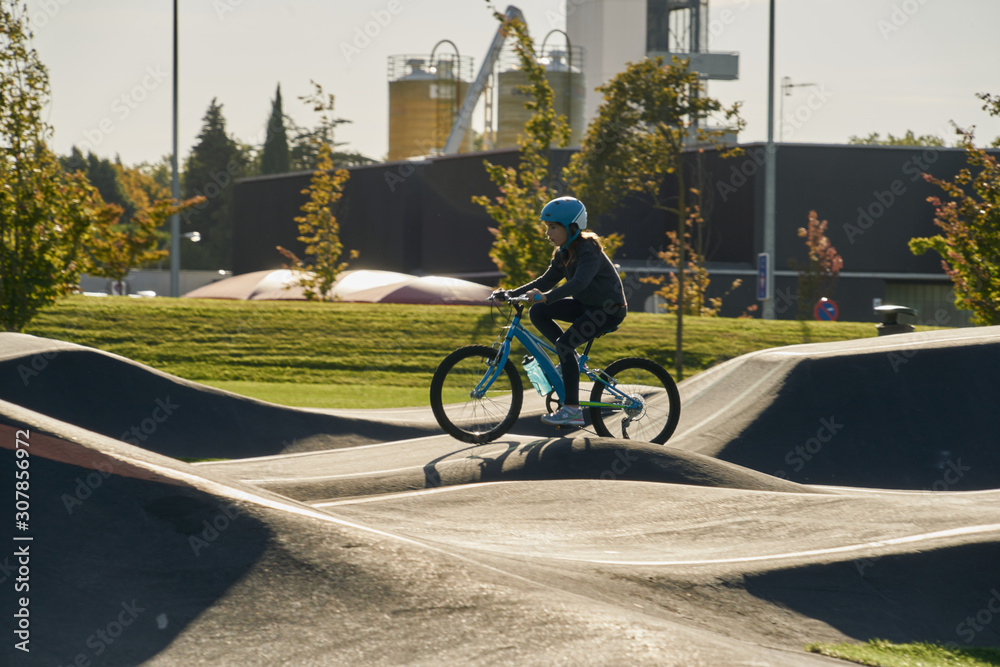 The bike lane for children. Children have fun on the race pump track. A ...