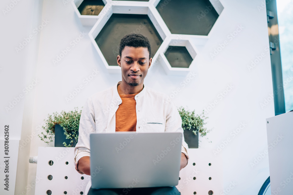 Skilled male programmer with dark skin developing web platform for IT ...