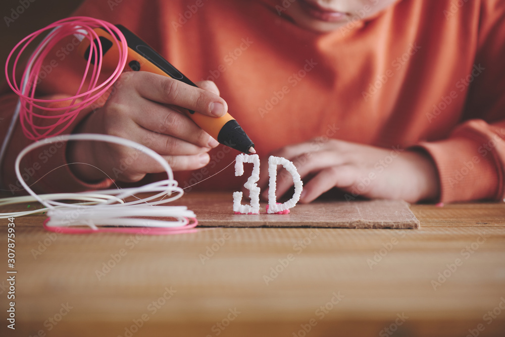 Boy makes volume plastic figures with 3D pen. STEM educational toy for ...