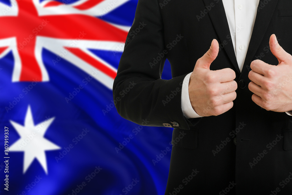 Australia businessman showing thumbs up behind country flag with copy ...