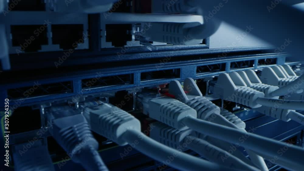 Macro Shot: IT Administrator Plugs in RJ45 Internet Connector into LAN ...