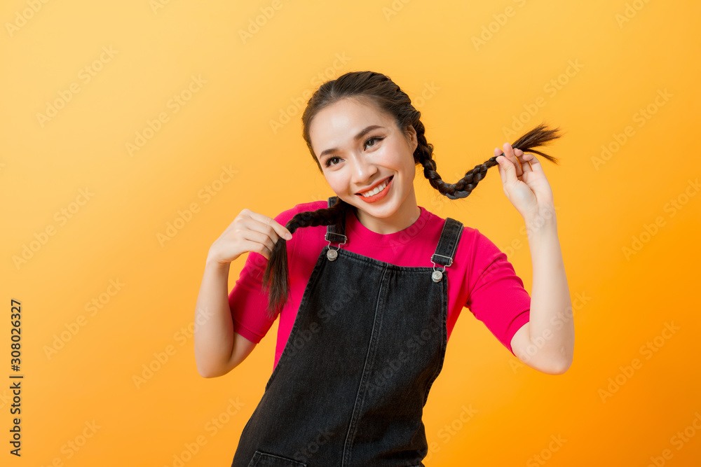 Cute mischievous young asian woman pulling her pigtails Stock Photo ...