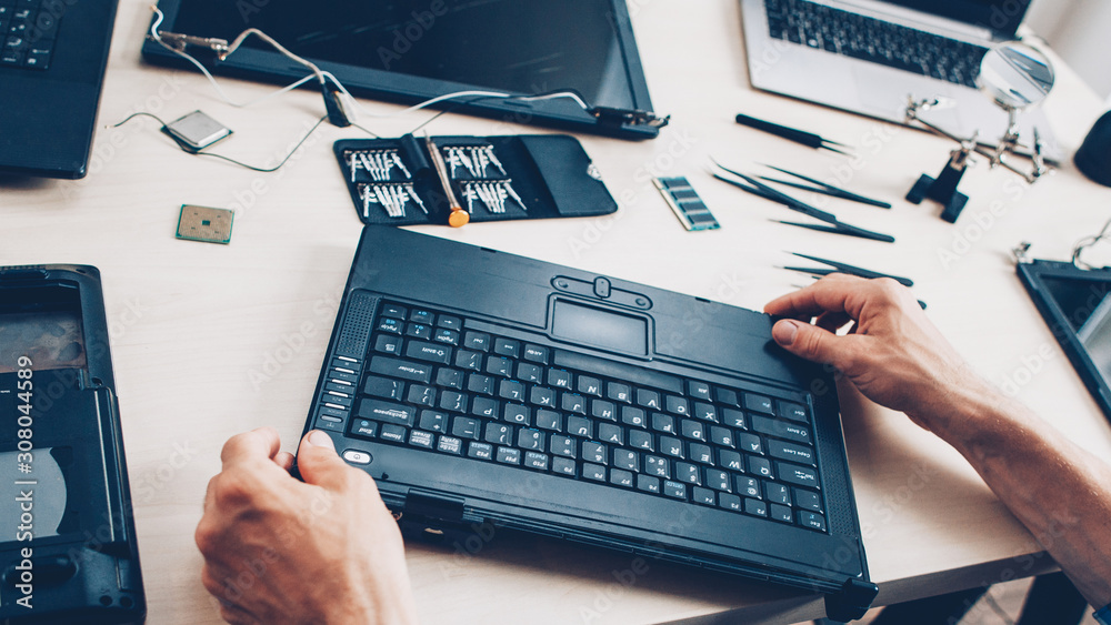 Technical service. Disassembled laptop keyboard. Engineer workplace ...