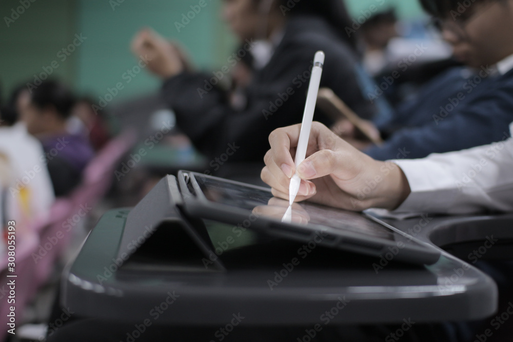 Students' hands are being recorded on tablets at international ...