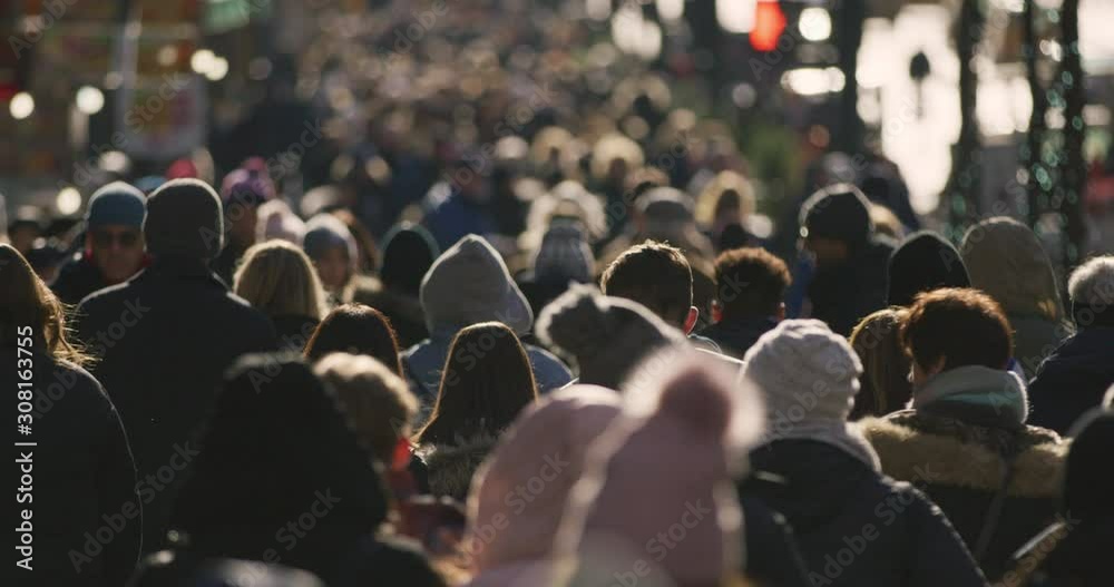 Crowd of people walking street in New York City winter backlit ...