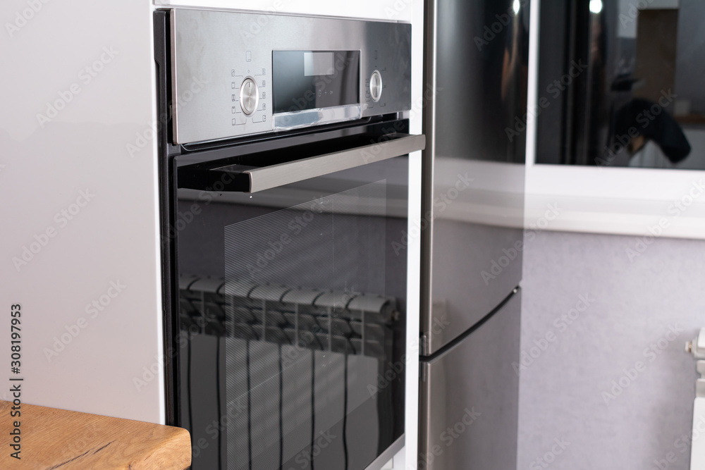 Empty open electric oven with hot air ventilation. New oven. Door is ...