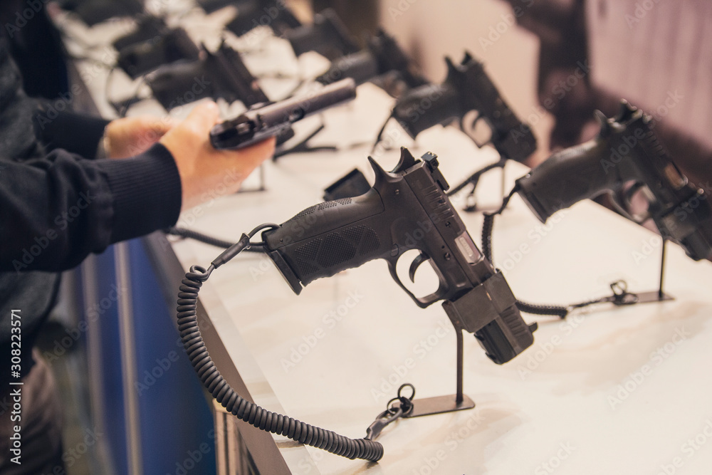 Gun in his hand. Exhibition and sale of weapons Stock Photo | Adobe Stock