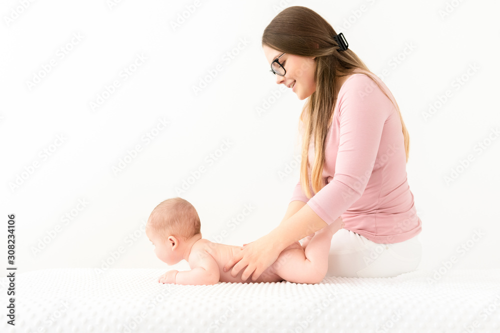 Baby massage background. Young therapist giving a baby boy a back ...