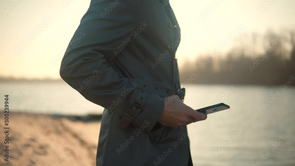 Man Hand Put Mobile Phone In Pocket.Businessman Work Outdoors.Man Takes ...