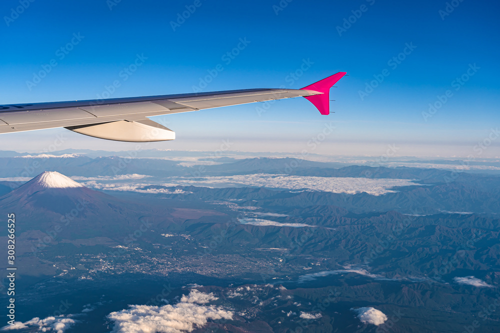 Aerial view of airplane wing with Mount Fuji ( Mt. Fuji ) in background ...