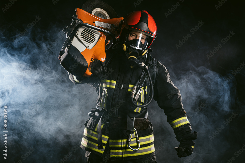 young adult firefighter saving people from fire wearing uniform and ...