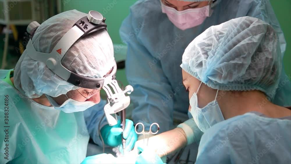 The surgeon is performing an operation on the eyes, close-up ...