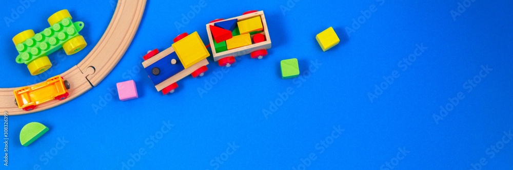 Baby kid toy background. Wooden toy train with colorful blocks on blue ...
