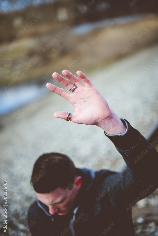 Male with his hand up while praying Stock Photo | Adobe Stock