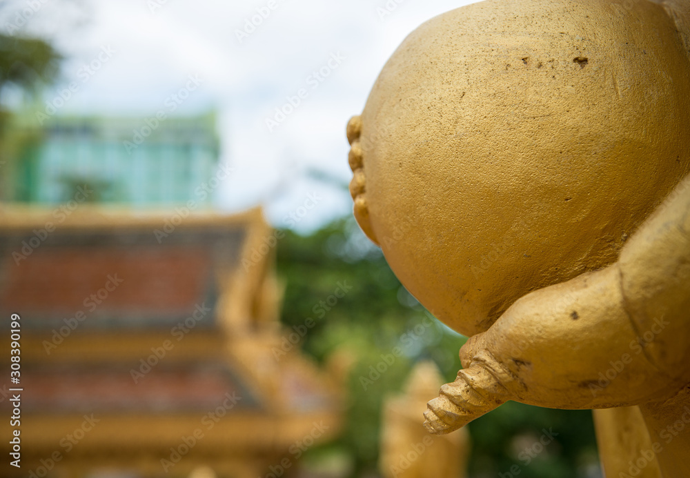 entrance of a buddhist temple in aisa with golden statue as a closeup ...
