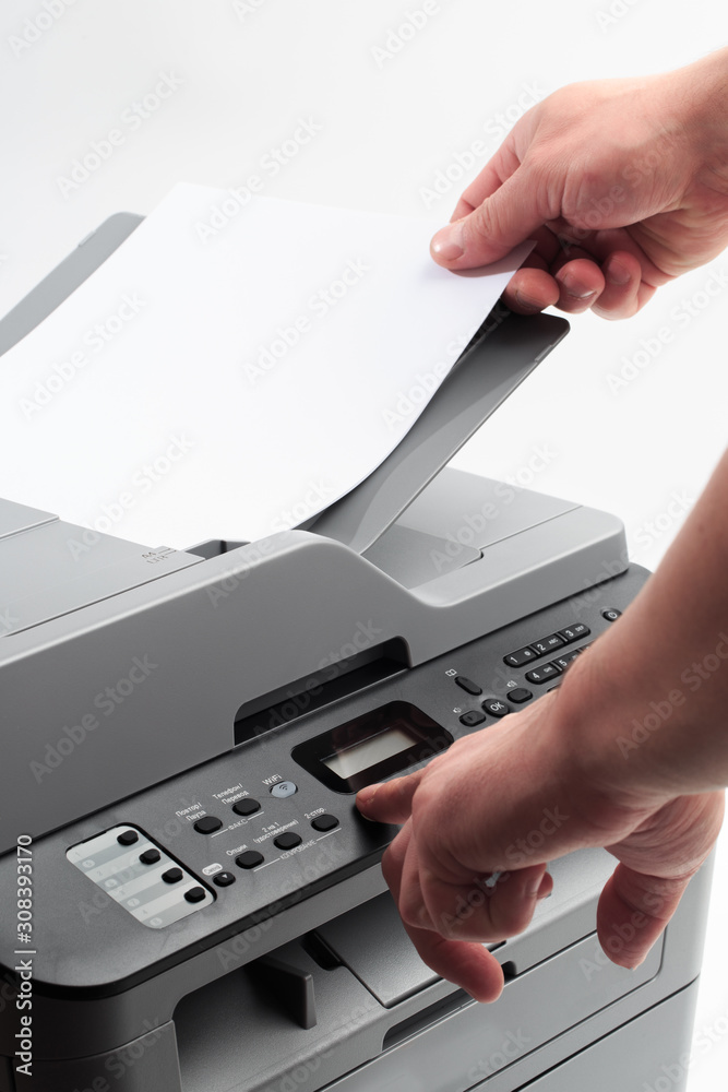 Hand press button on panel of printer. printer scanner laser office ...