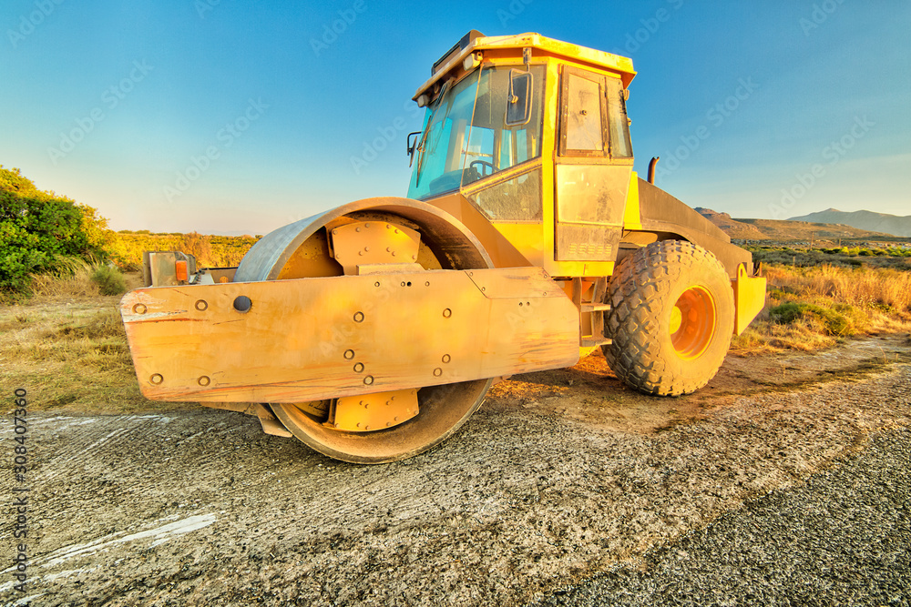 Side view of steamroller in a suggestive construction site. Concept of ...