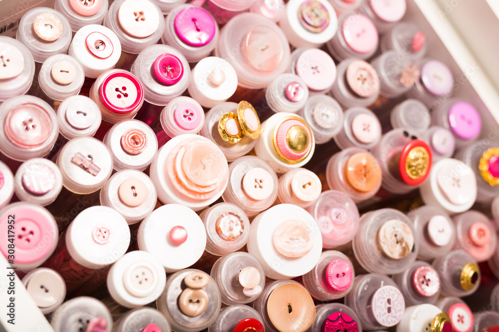 Buttons in tubes on store shelves Stock Photo | Adobe Stock