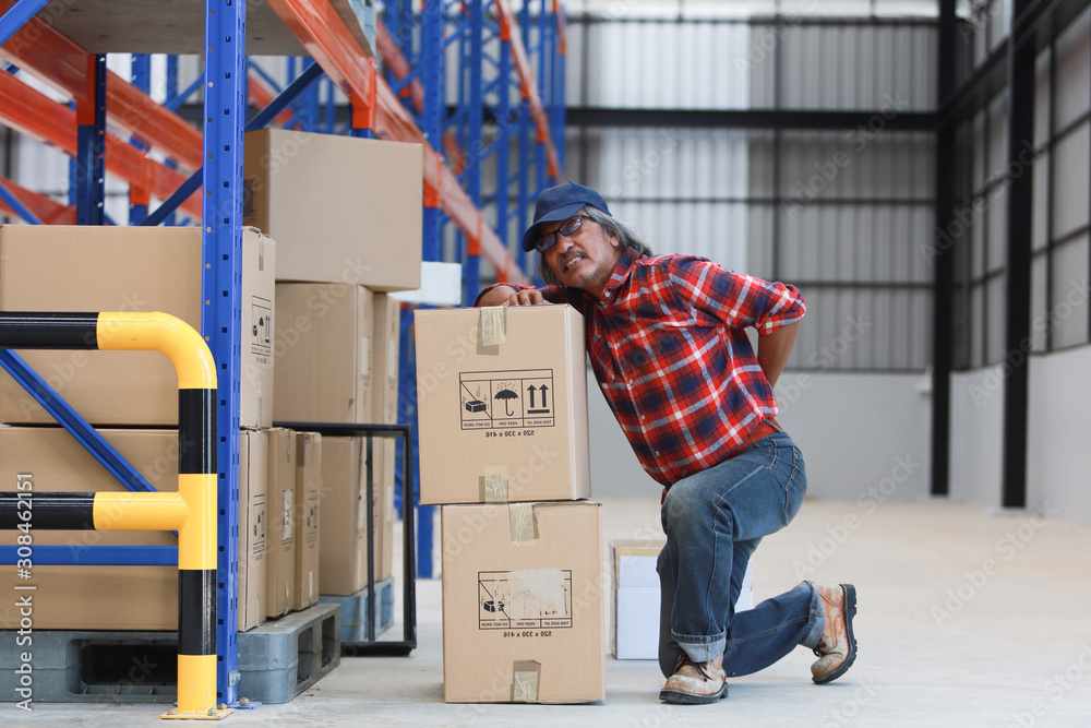 Asian worker man hurt his back .lift heavy box in factory Stock Photo ...