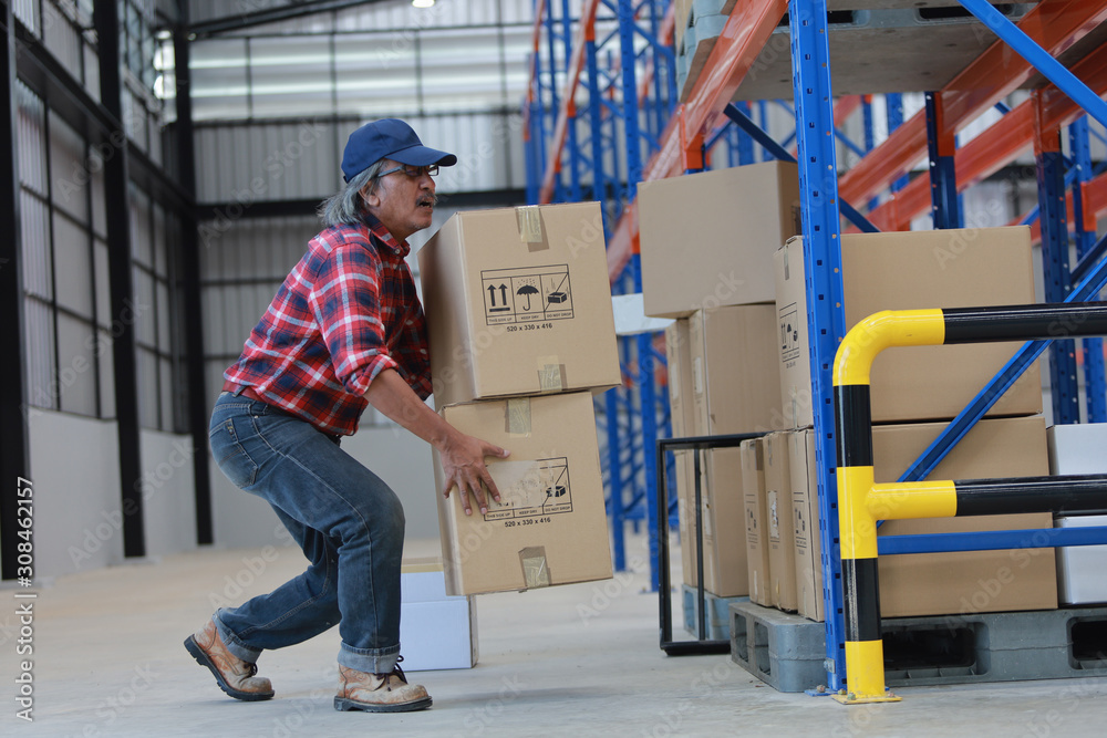 Asian worker man hurt his back .lift heavy box in factory Stock Photo ...