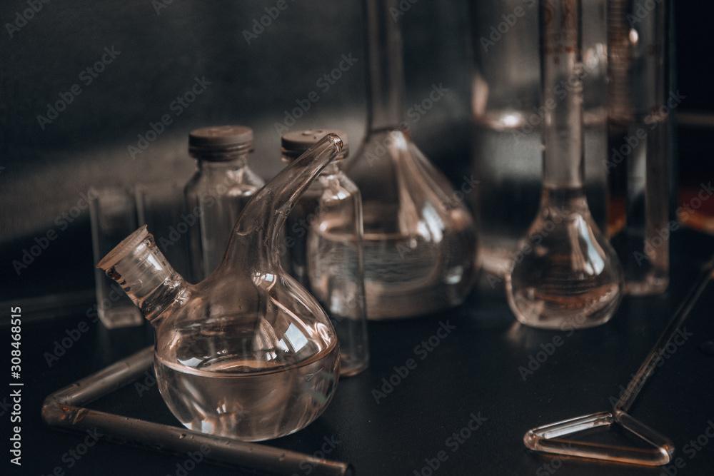 Set with different laboratory glassware and liquid for analysis on ...